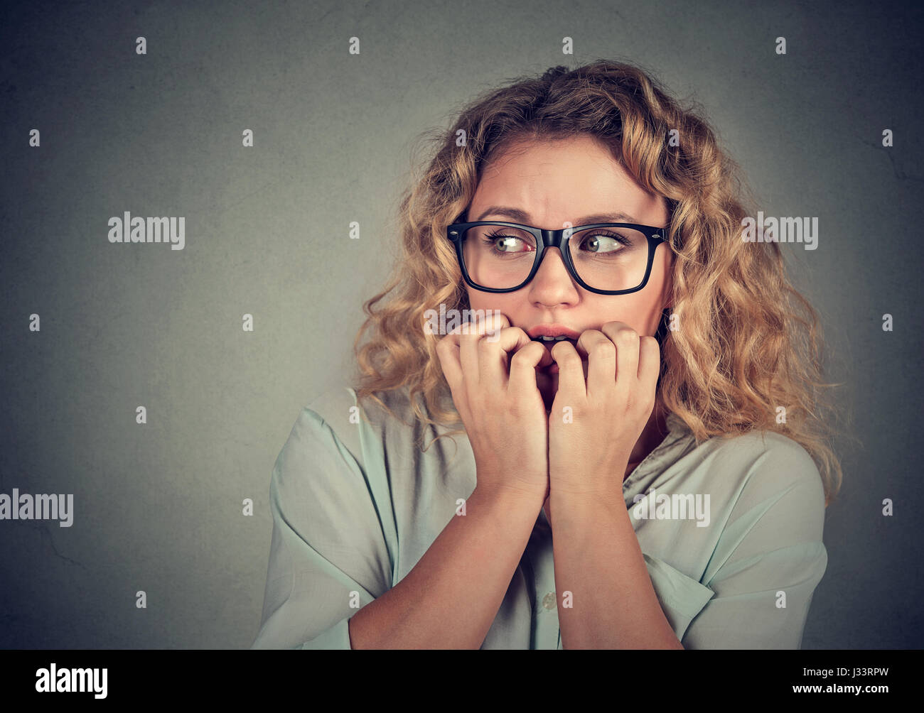 Closeup portrait nervous stressed young woman biting fingernails ...