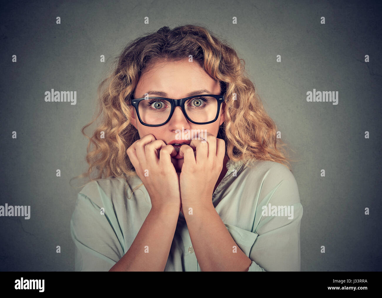 Closeup portrait nervous stressed young woman biting fingernails ...