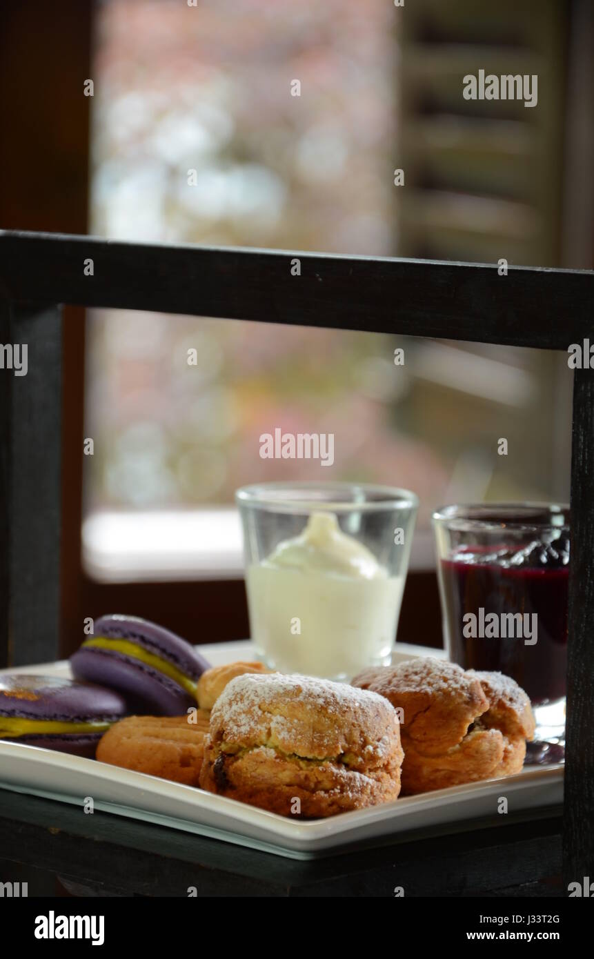 Scone and macaroon with sweet sauce afternoon tea set Stock Photo - Alamy