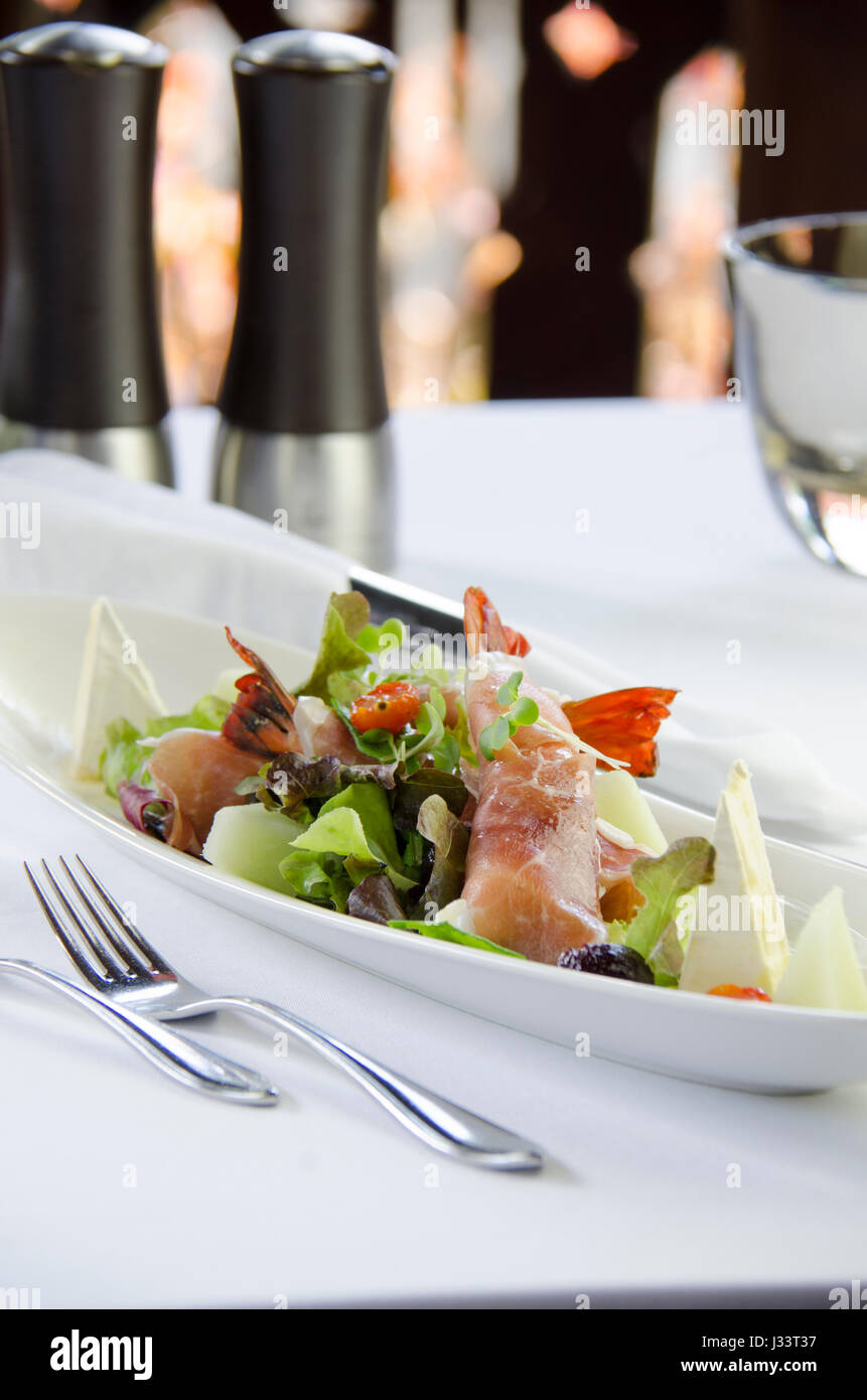 Parma Ham Salad on white table in Italian restaurant Stock Photo - Alamy