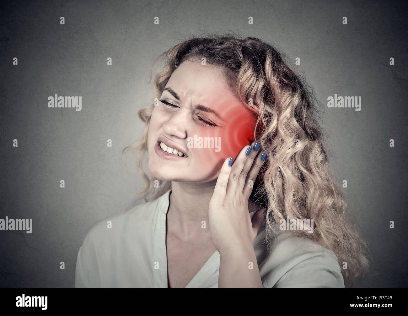 Tinnitus. Closeup up side profile sick female having ear pain touching ...