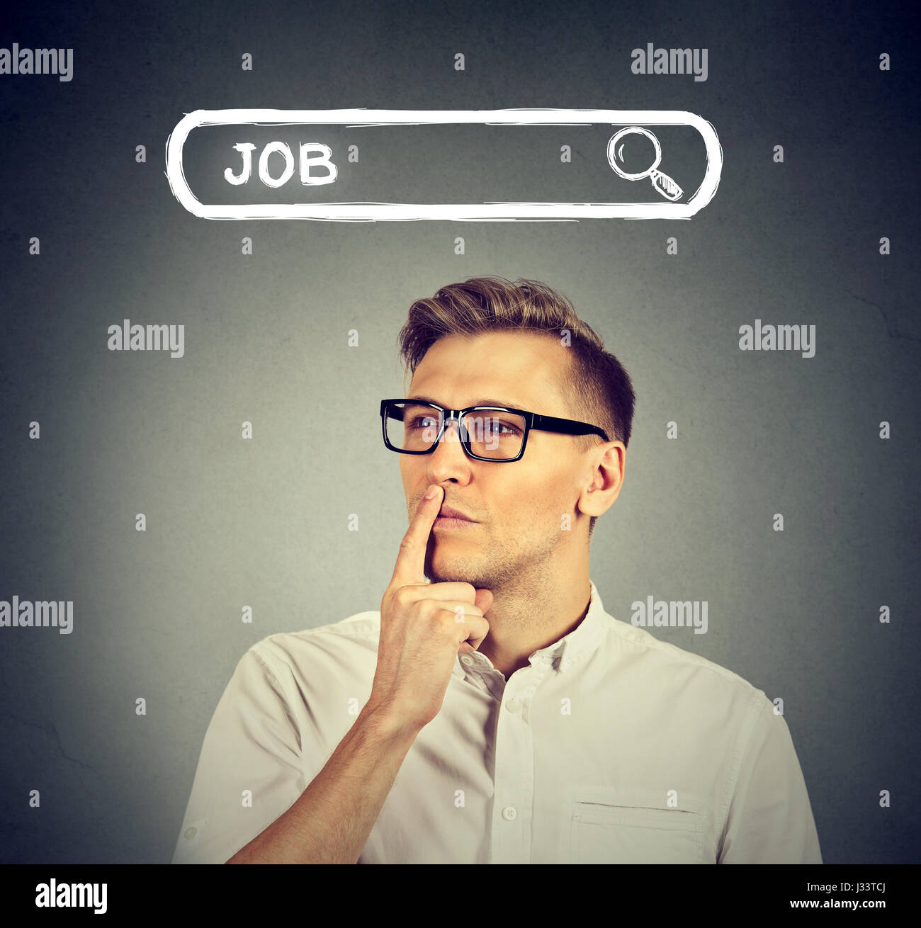 Man in glasses thinking looking for a new job isolated on gray wall ...