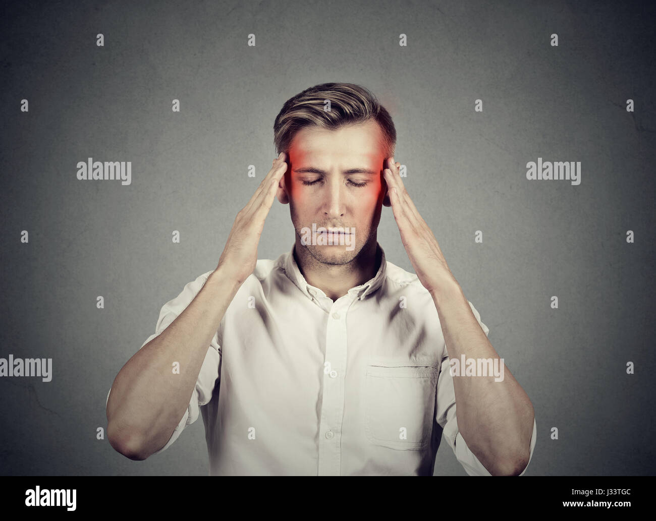 Man with headache thinking very intensely concentrating isolated on ...