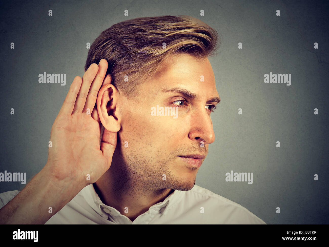 Side profile man holds his hand near ear and listens carefully isolated ...