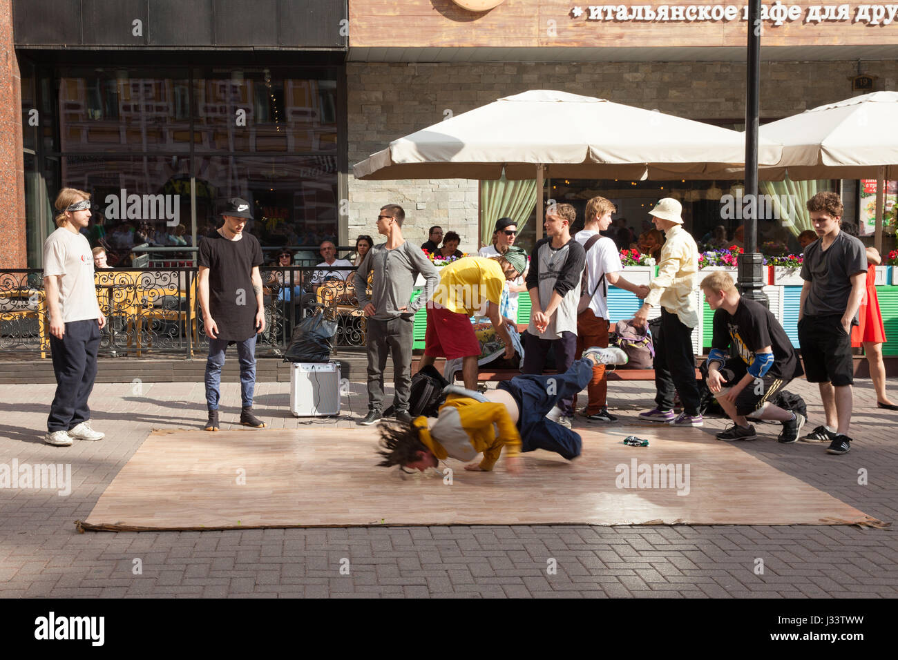 MOSCOW, RUSSIA - JUNE 24: Guy dancing breakdance surrounded by his crew ...