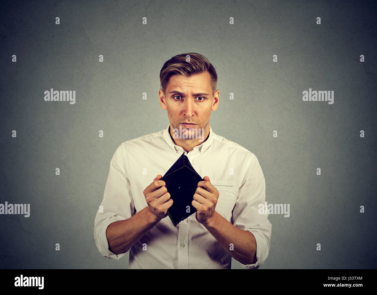 Man with no money. Businessman holding empty wallet Stock Photo - Alamy