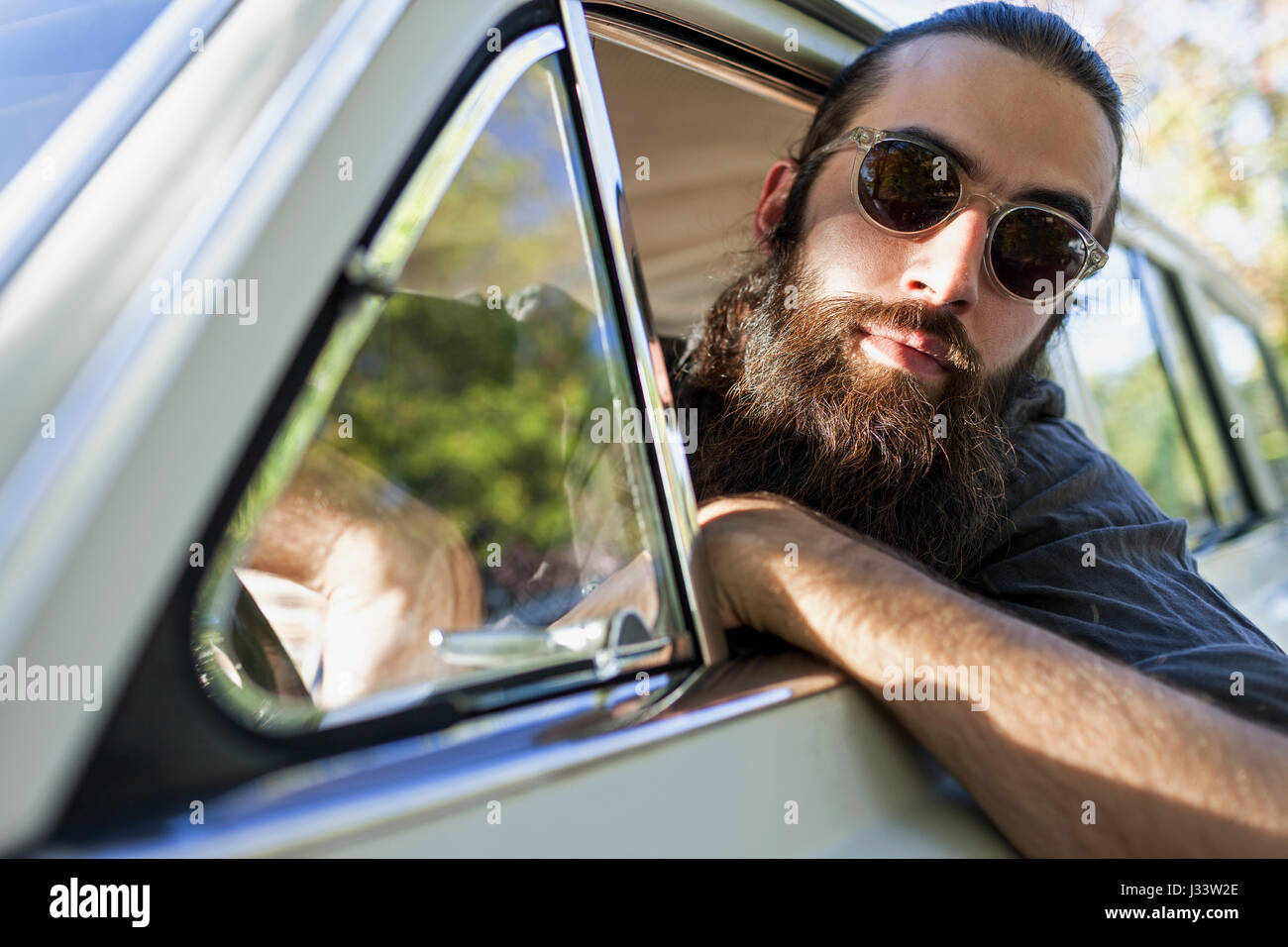 Handsome young man sitting in a car Stock Photo - Alamy