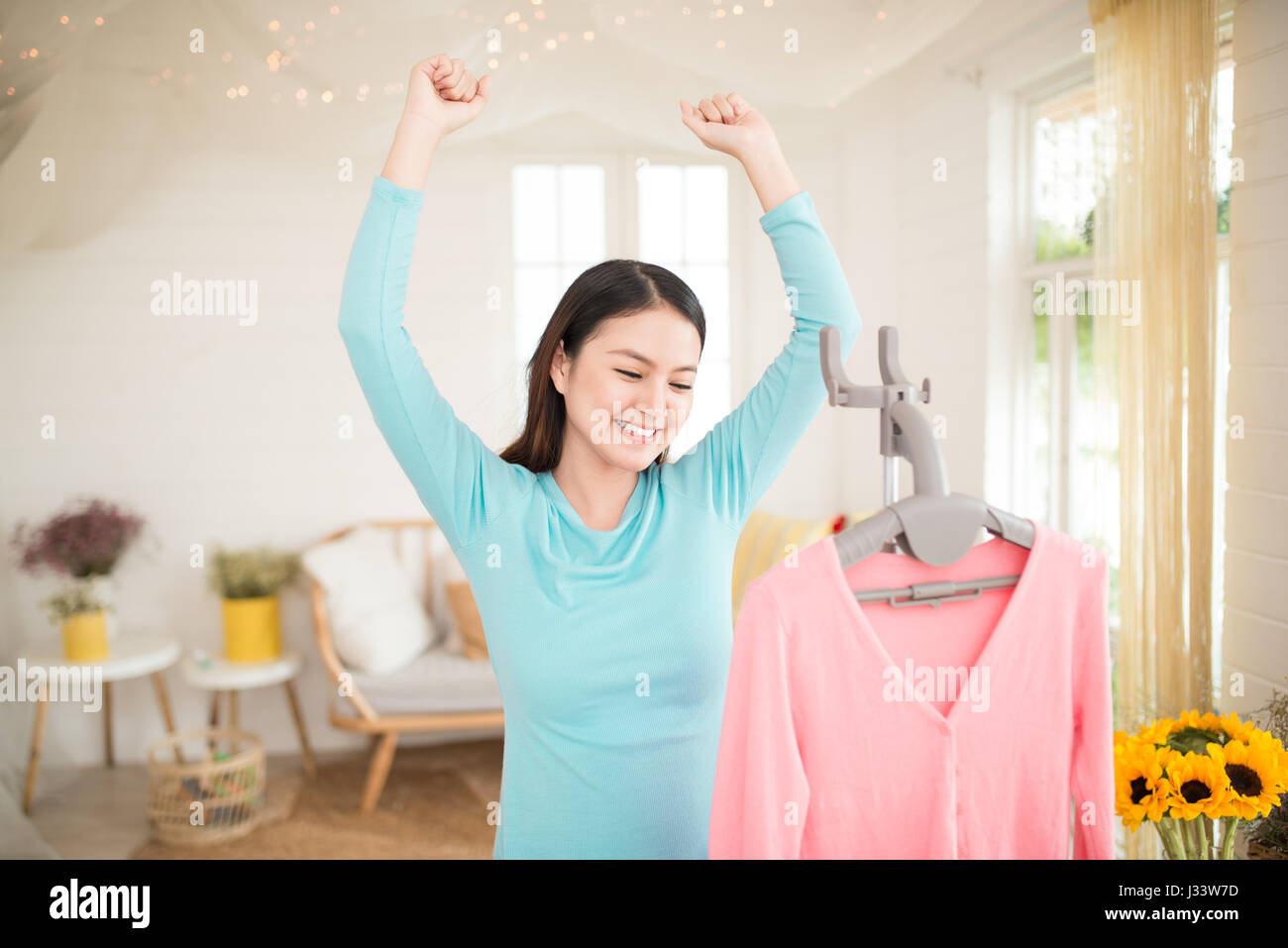 Happy young asian woman finish steaming clothes in room Stock Photo - Alamy