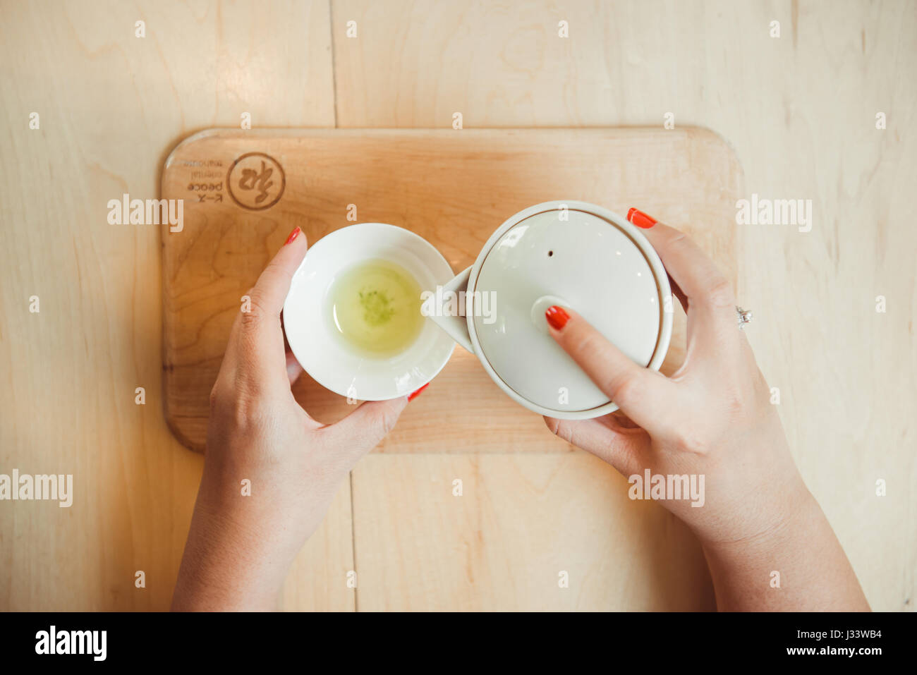 Hands holding Japanese Sencha Tea in clay pot Stock Photo - Alamy