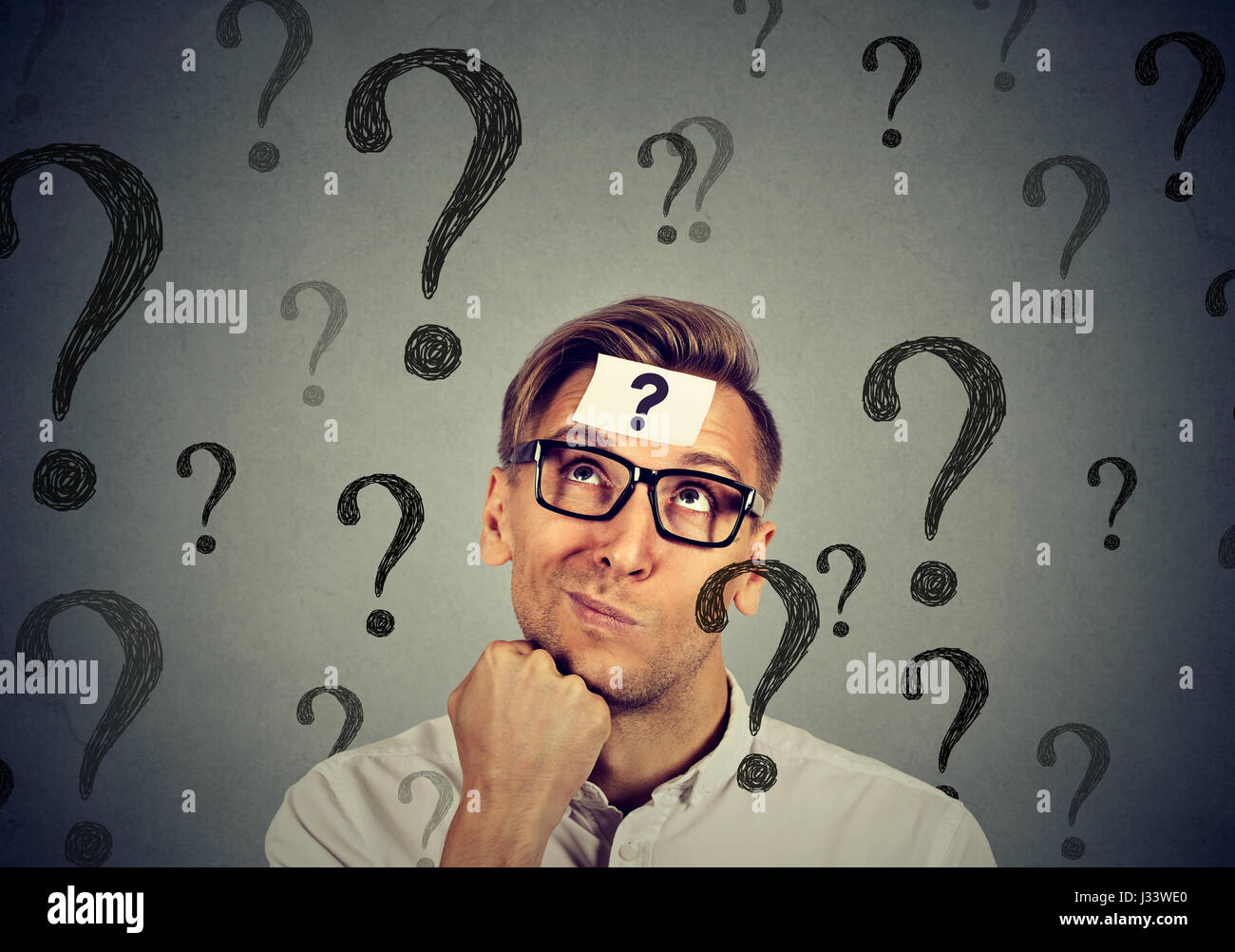 Thoughtful confused handsome man has too many questions and no answer ...