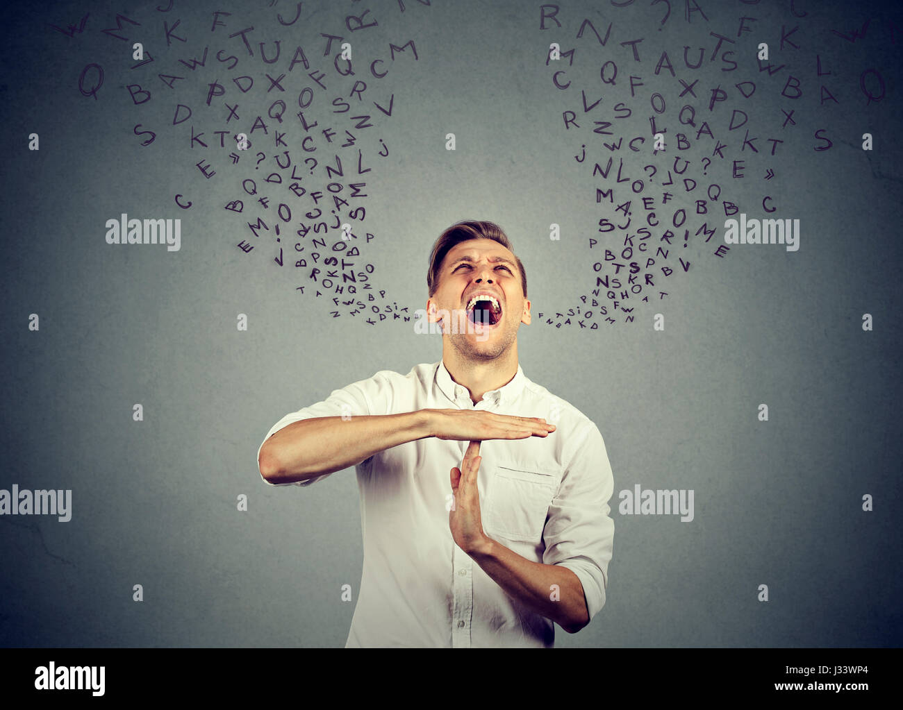 Young man showing time out hand gesture, frustrated screaming to stop ...