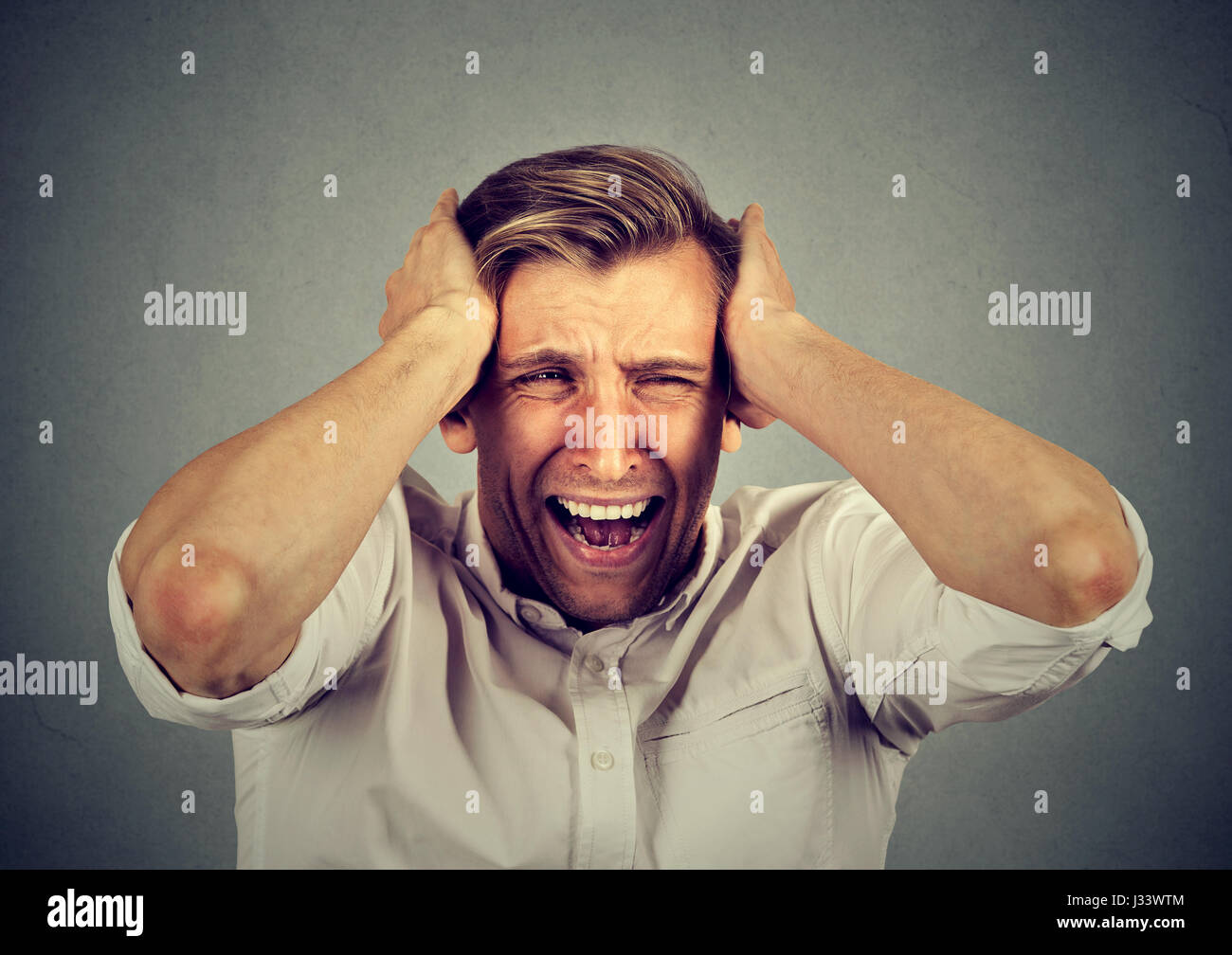 stressed man upset frustrated screaming isolated on gray wall ...