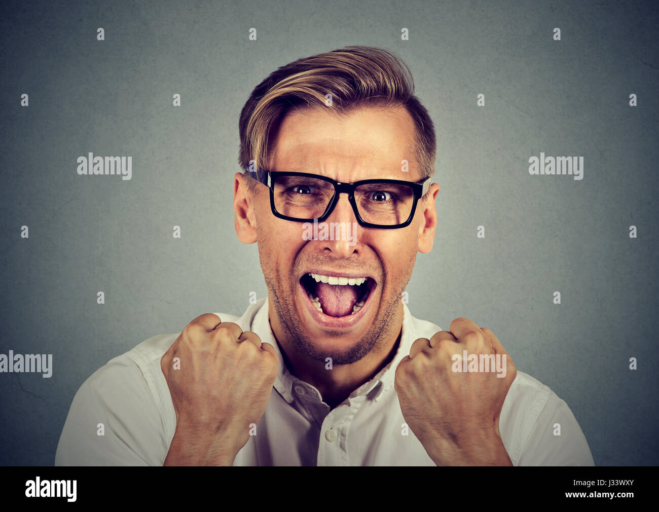 Angry young man screaming Stock Photo - Alamy