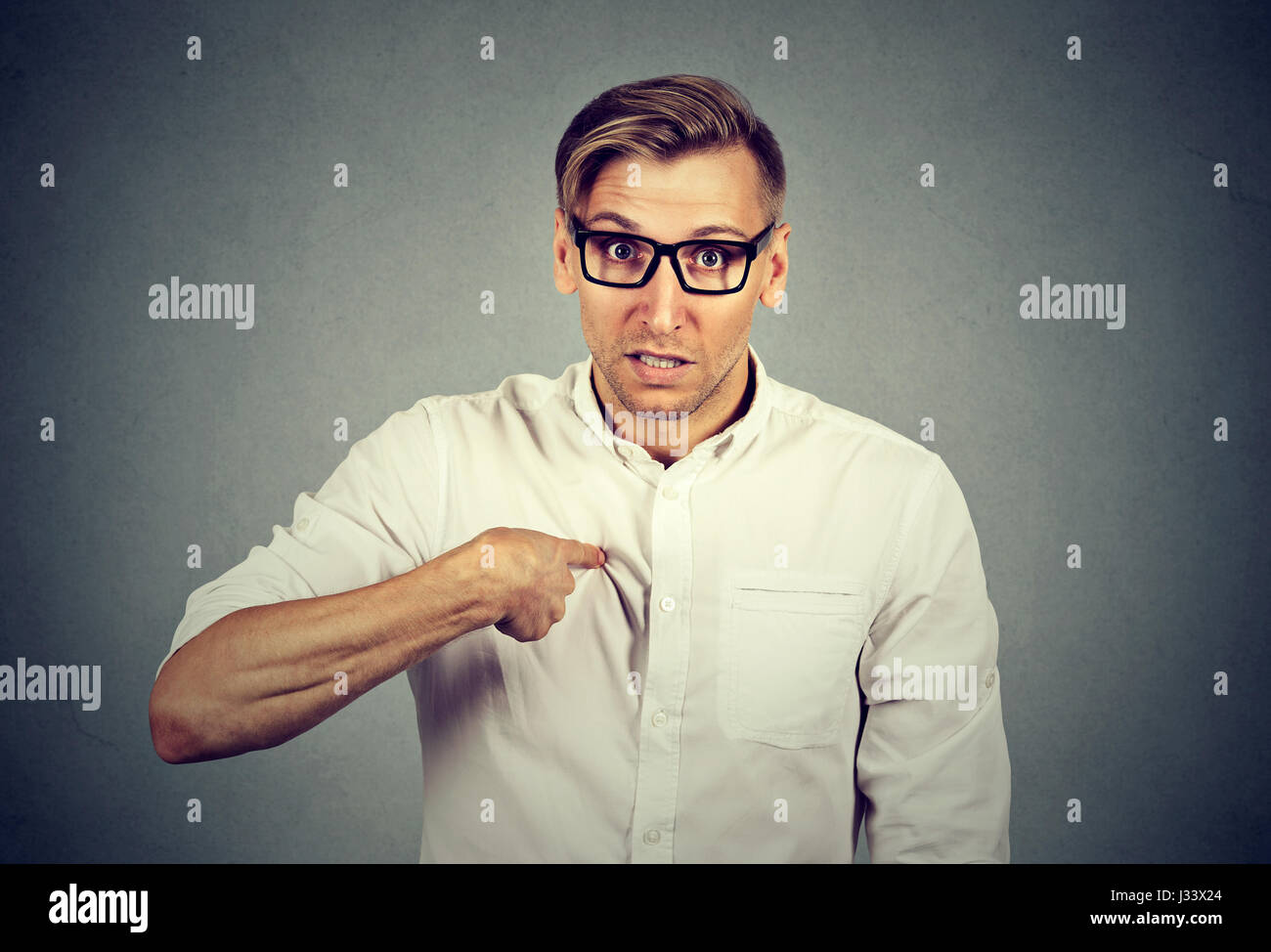 angry, mad, unhappy young guy pointing at himself you mean me, you ...