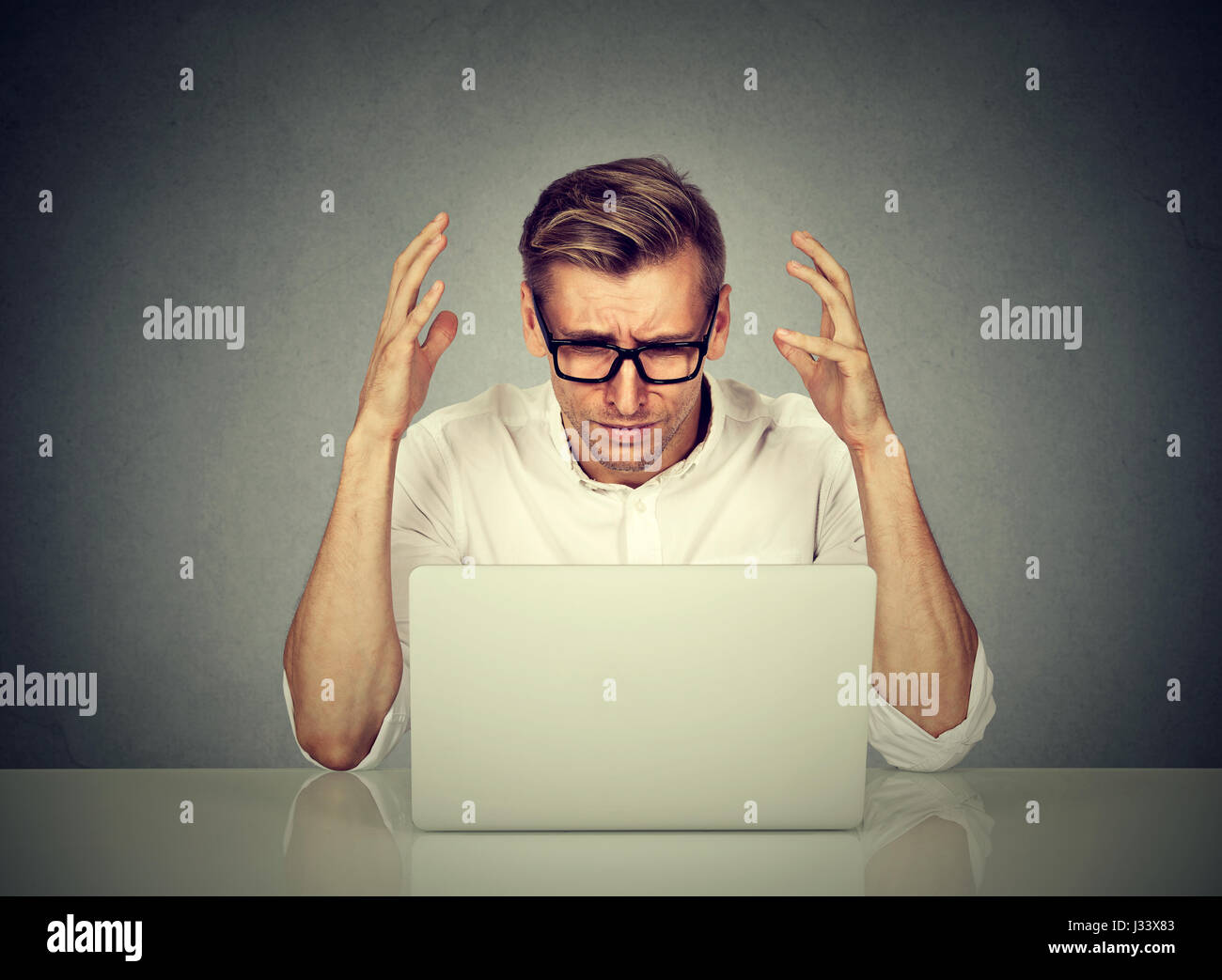 Stressed man working on computer. Negative human emotion face ...