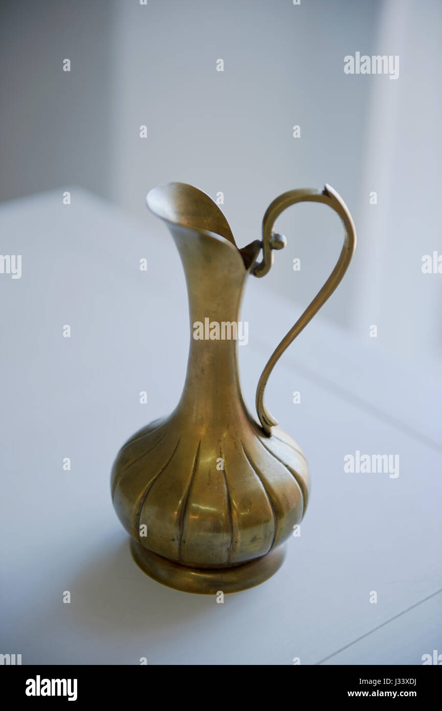Old bronze pitcher on a light background. Retro Oriental style Stock ...