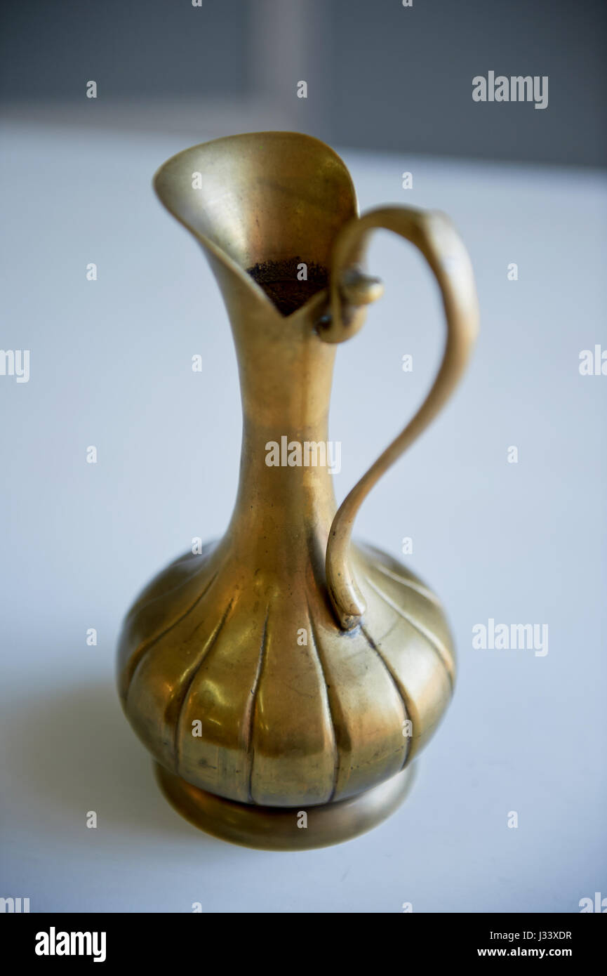 Old bronze pitcher on a light background. Retro Oriental style Stock ...