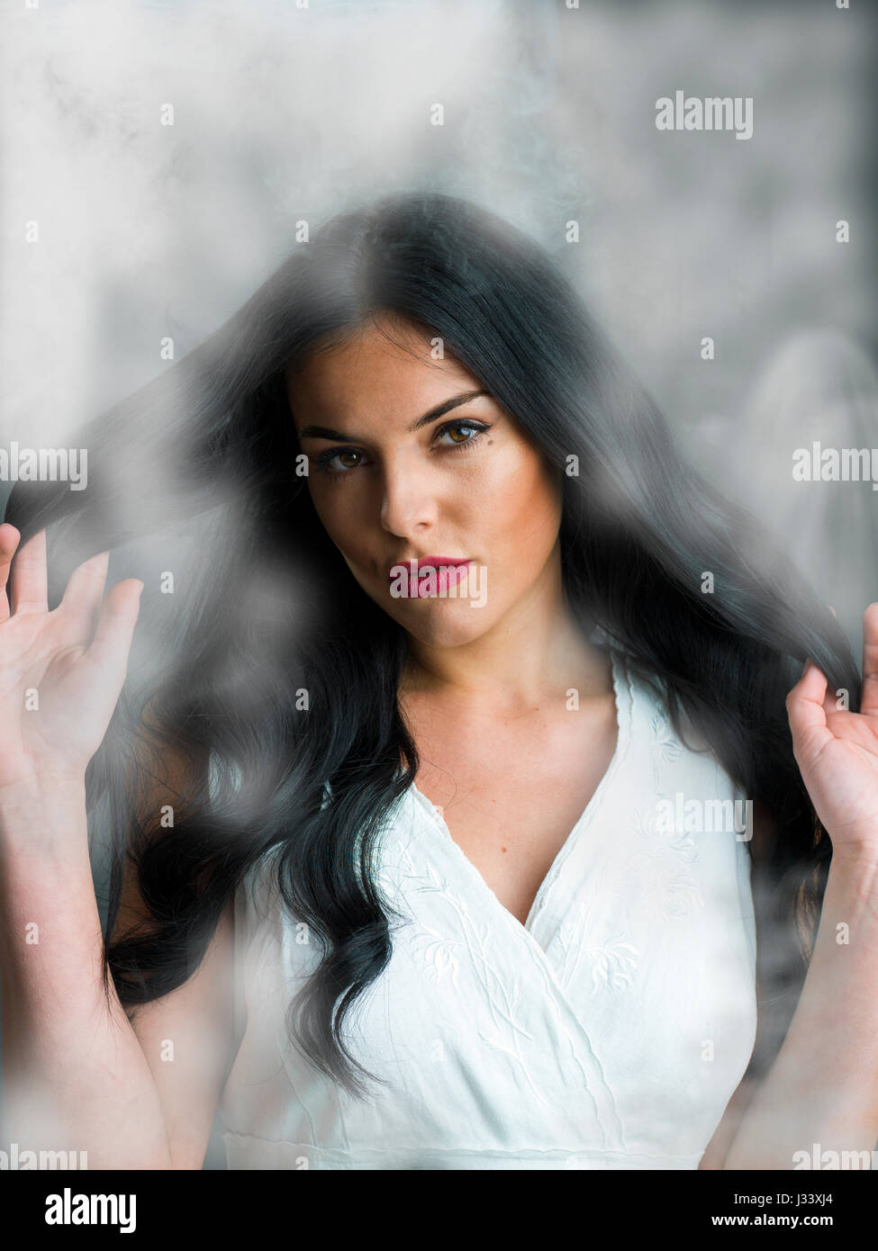 Poppy Haskell modelling in fog Stock Photo - Alamy