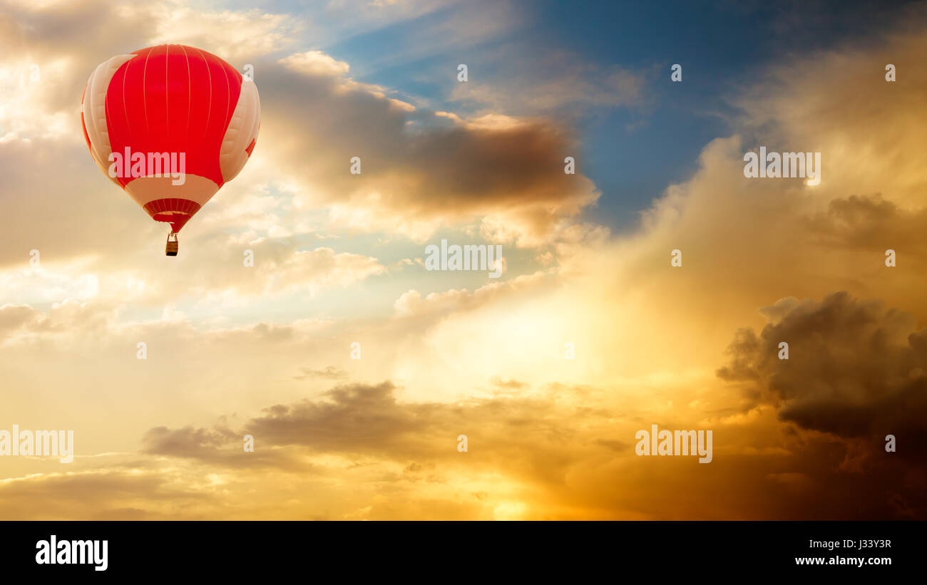 Red Hot Air Balloon Flying over Golden Sunset Sky. Amazing Evening ...