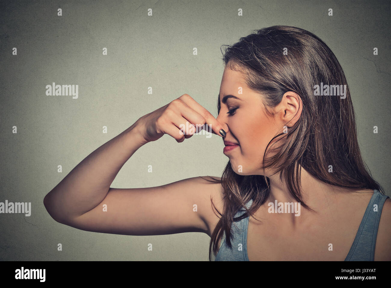Side profile portrait headshot woman pinches nose with fingers looks ... Side profile portrait headshot woman pinches nose with fingers looks ...