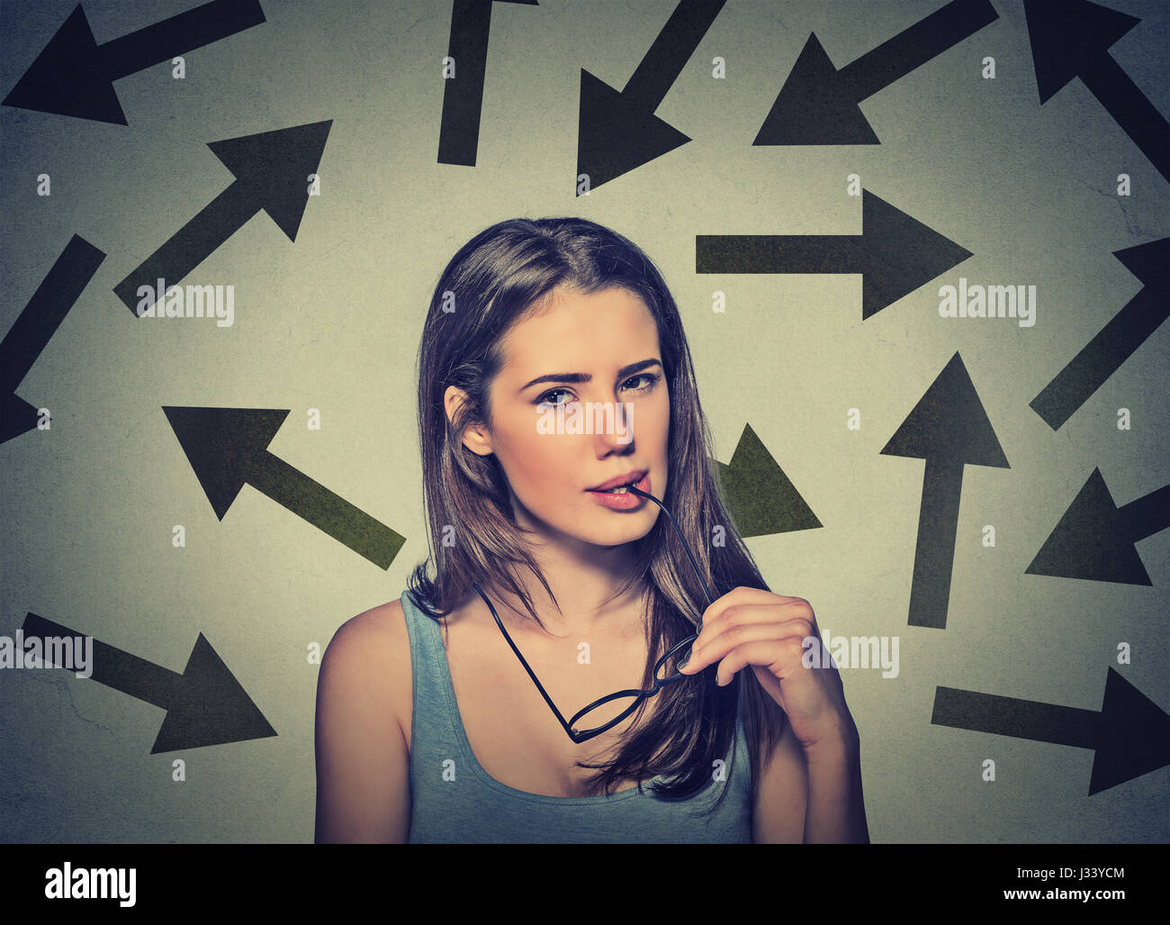 Doubtful confused skeptical young woman on gray wall background. Human ...