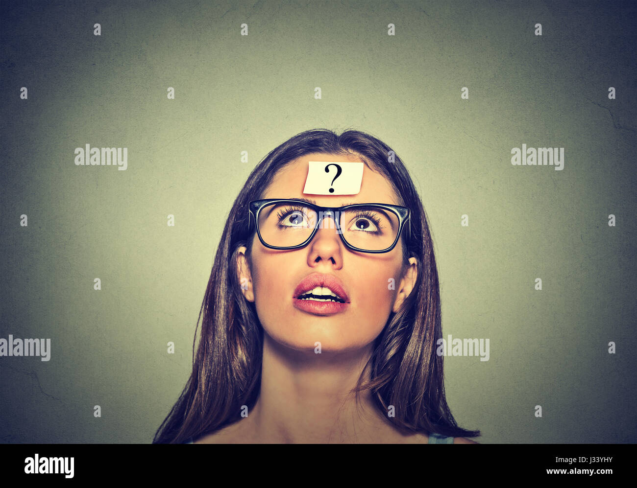 Thoughtful woman looking up Stock Photo - Alamy