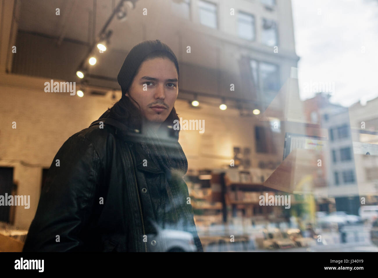 Portrait of a young man through a window Stock Photo - Alamy