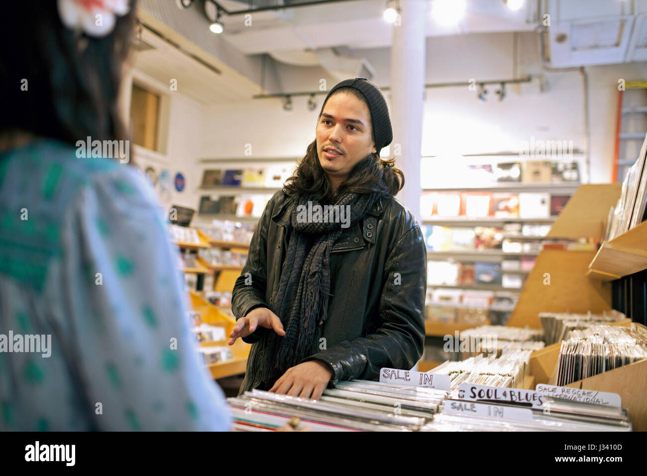 People talking in a record store Stock Photo - Alamy