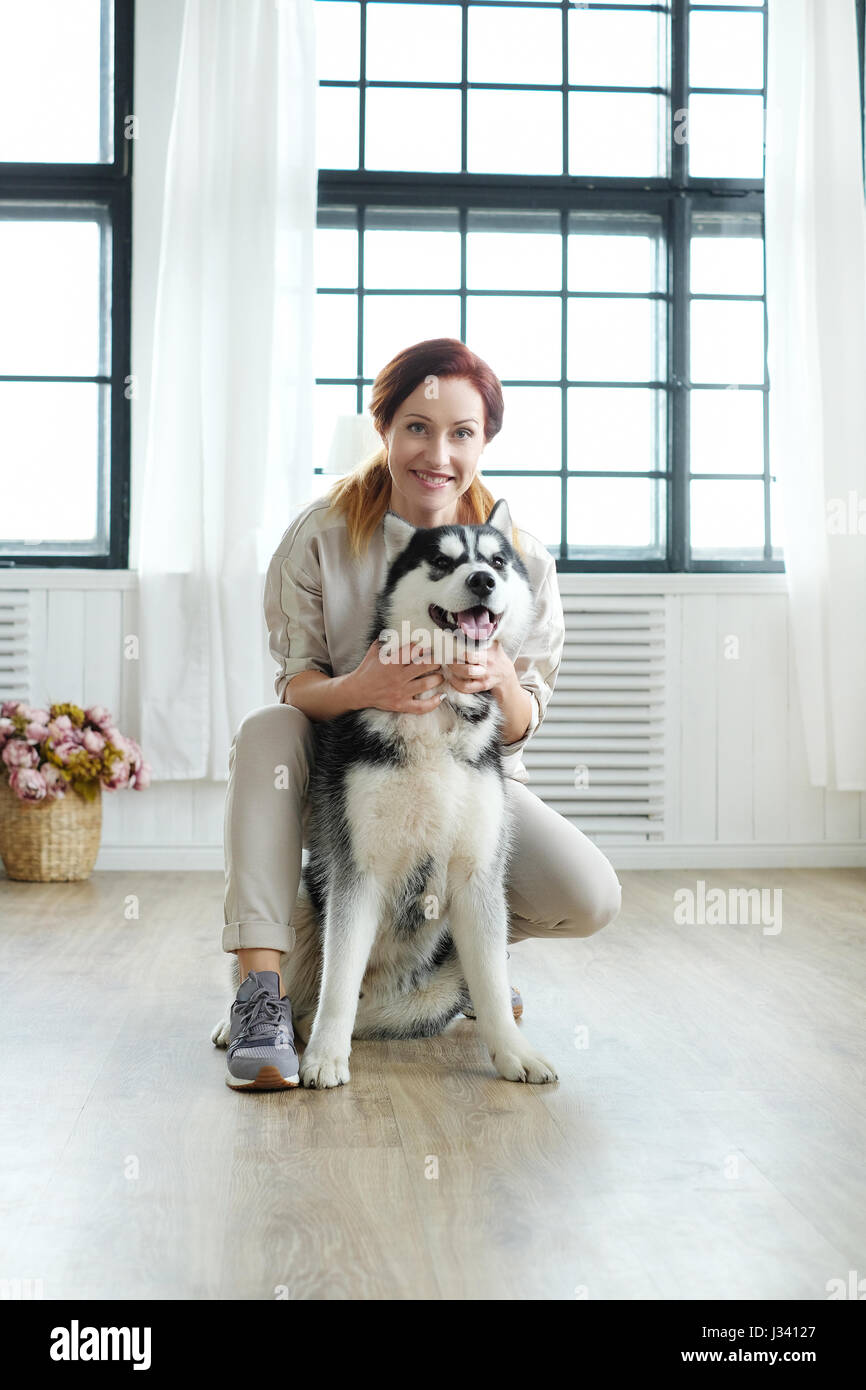 Woman with husky at home Stock Photo - Alamy