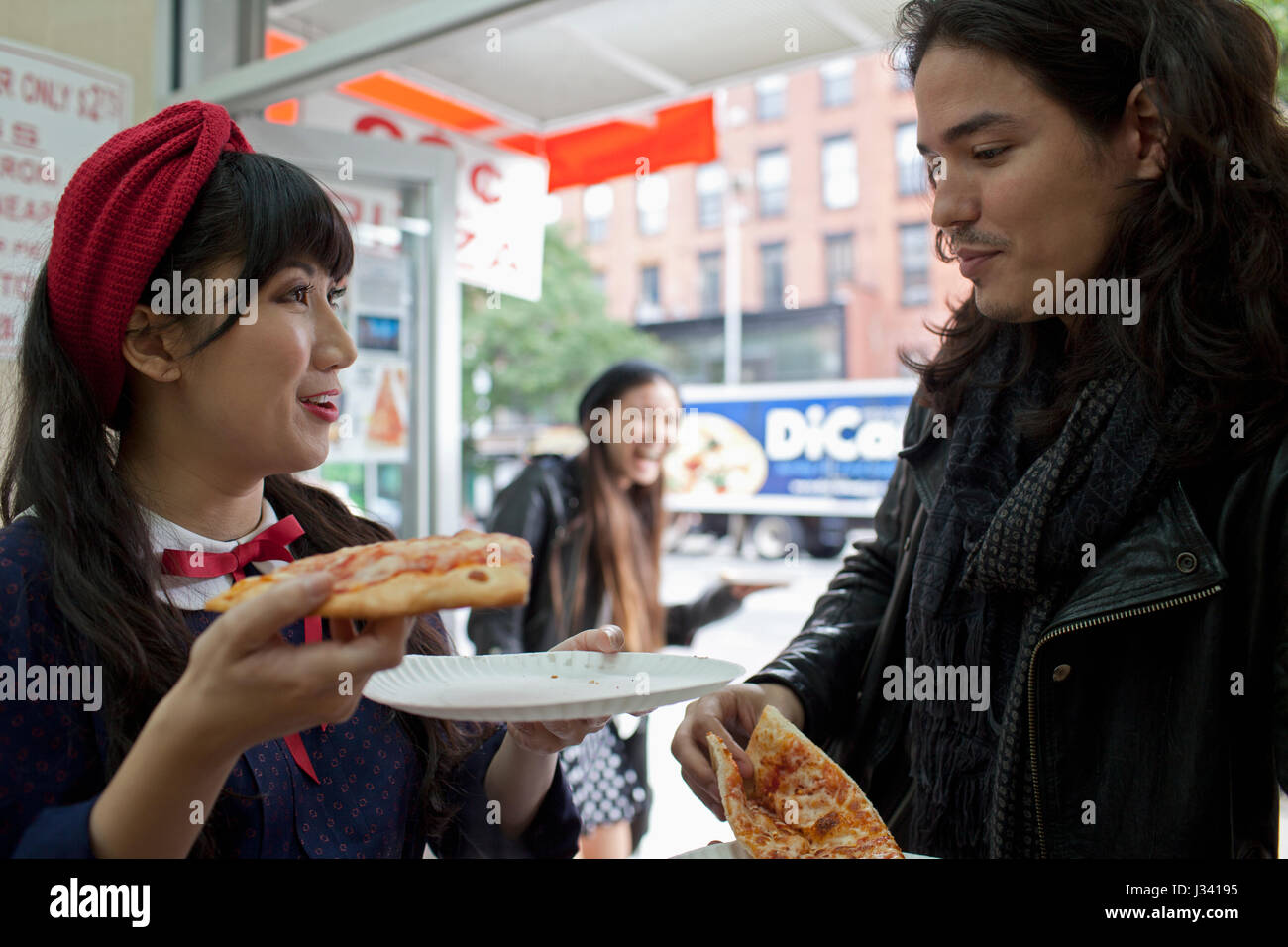 Friends hanging out eating pizza Stock Photo - Alamy