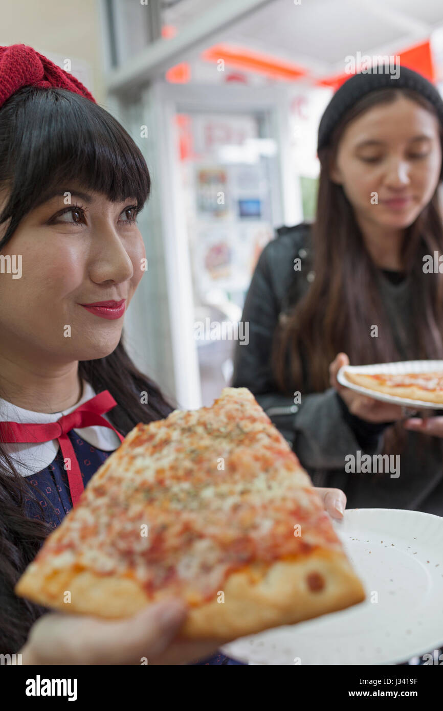 Friends hanging out eating pizza Stock Photo - Alamy