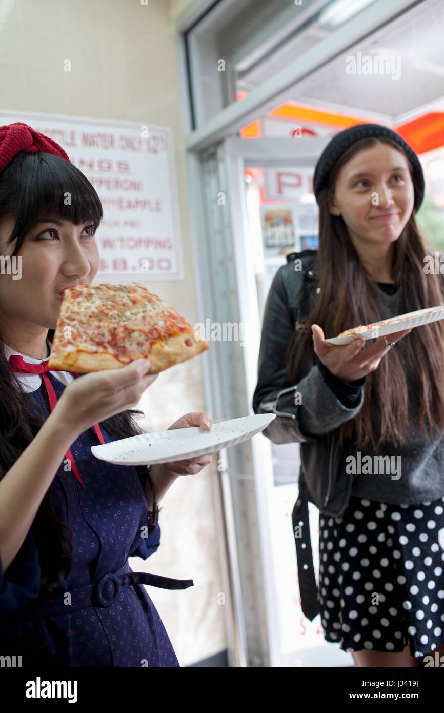 Friends hanging out eating pizza Stock Photo - Alamy
