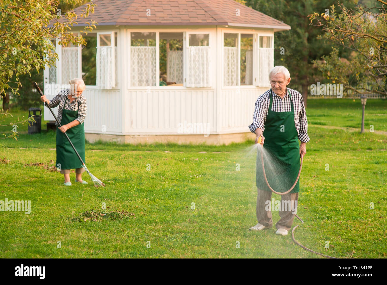 Man with hose hi-res stock photography and images - Alamy