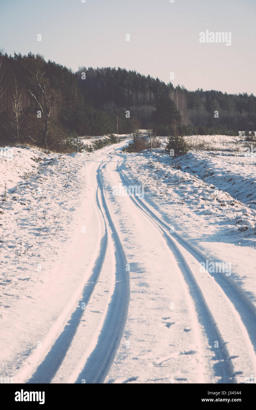 snowy winter road with tire markings and blue sky - retro vintage ...