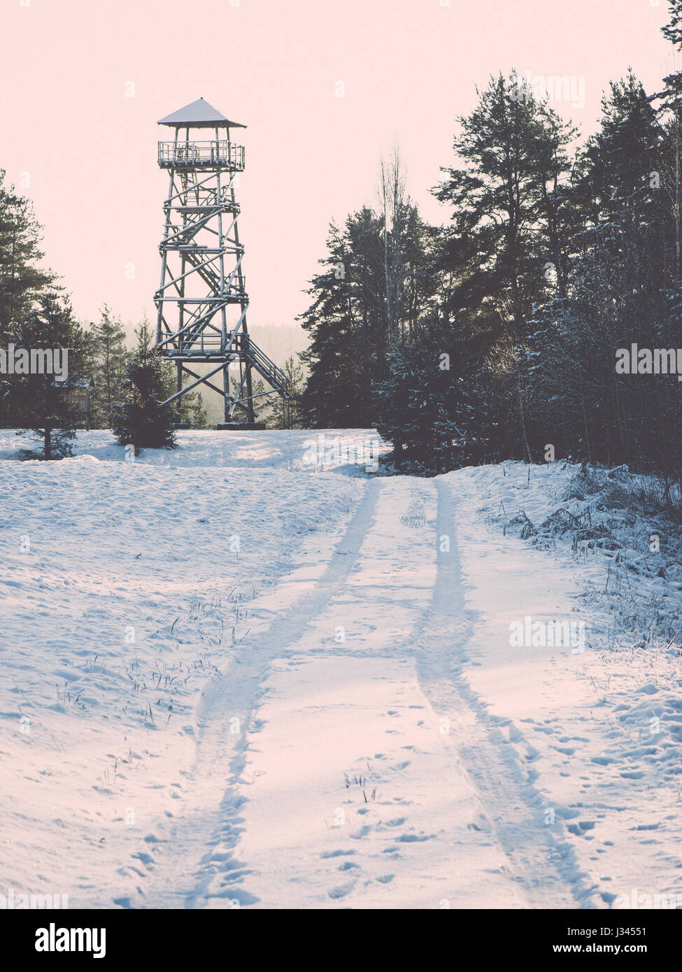beautiful snowy winter landscape with watchtower in forest and blue sky ...