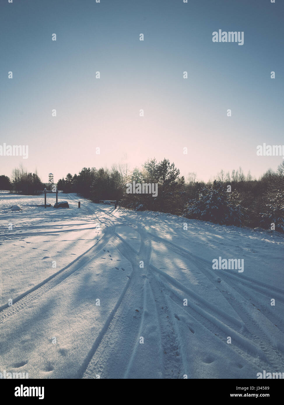 snowy winter road with tire markings and blue sky - retro vintage ...