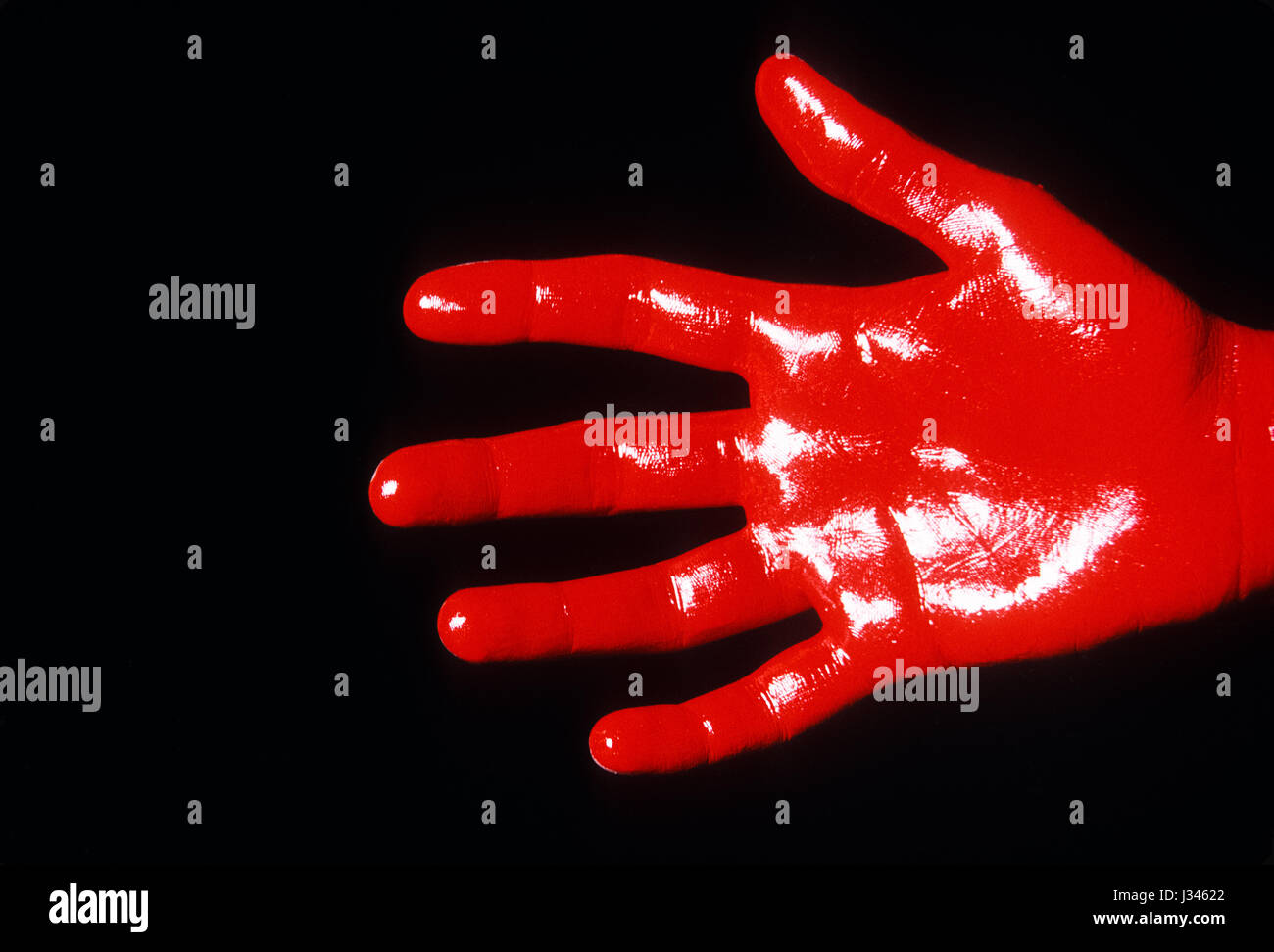 Red Hand on black background Stock Photo - Alamy