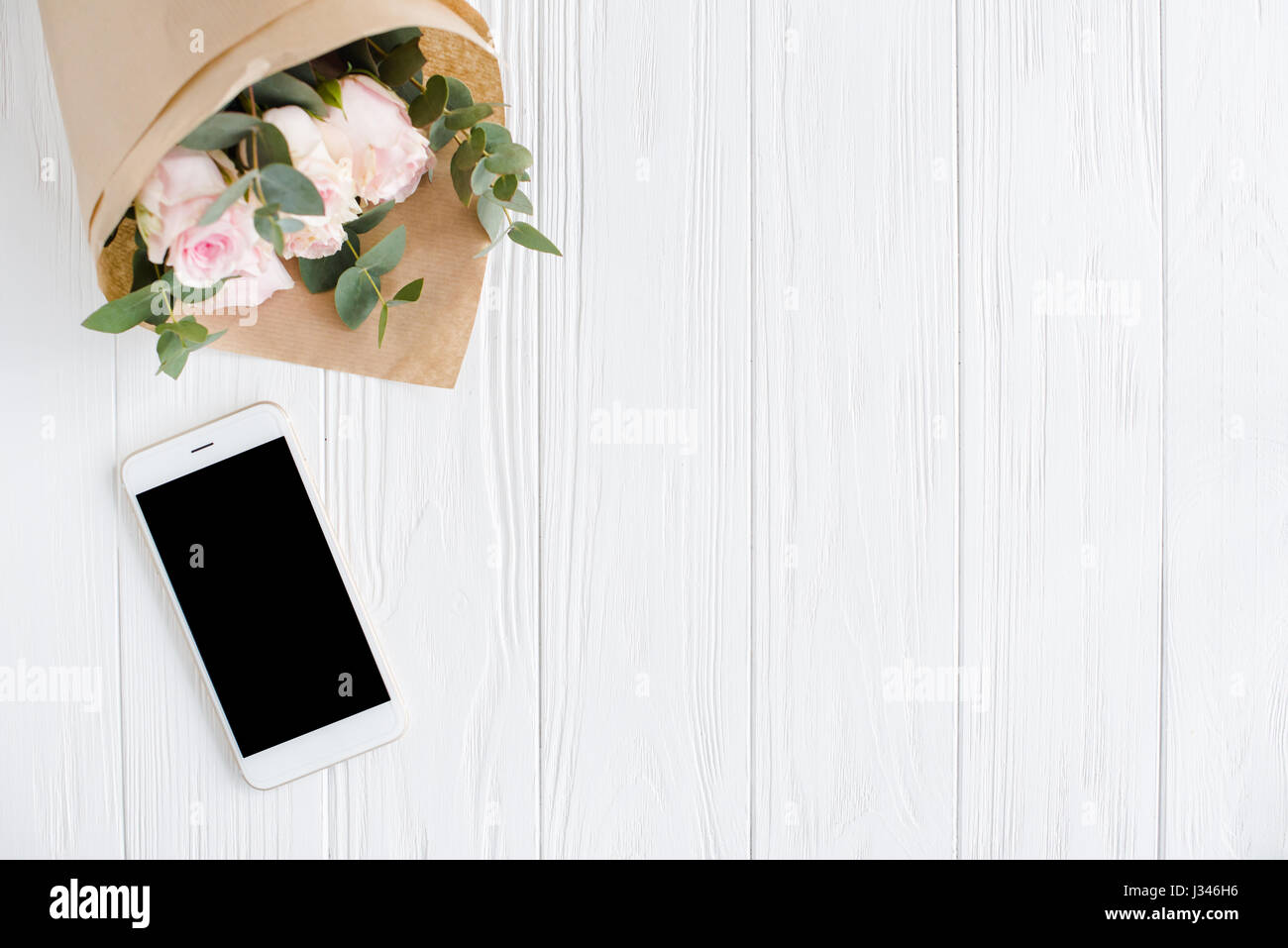 Simple feminine background with smartphote mock-up and roses on white ...