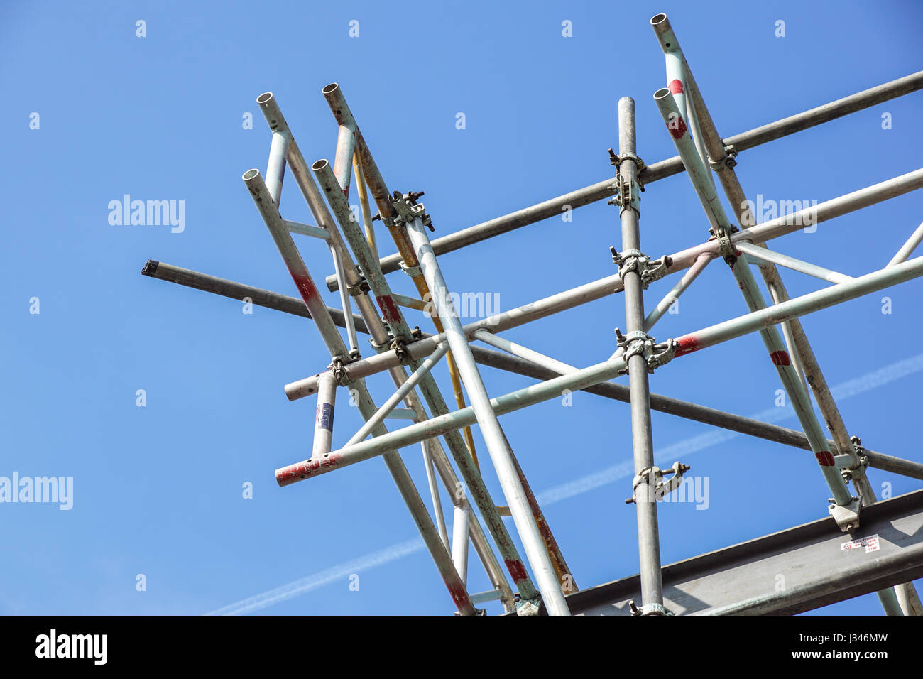 metal scaffolding in building and blue sky background Stock Photo - Alamy
