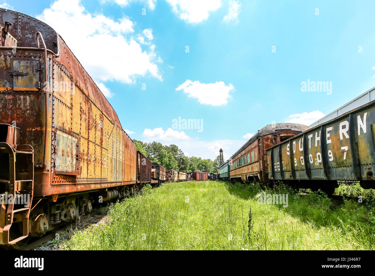 An old abandoned railroad train on tracks Stock Photo - Alamy