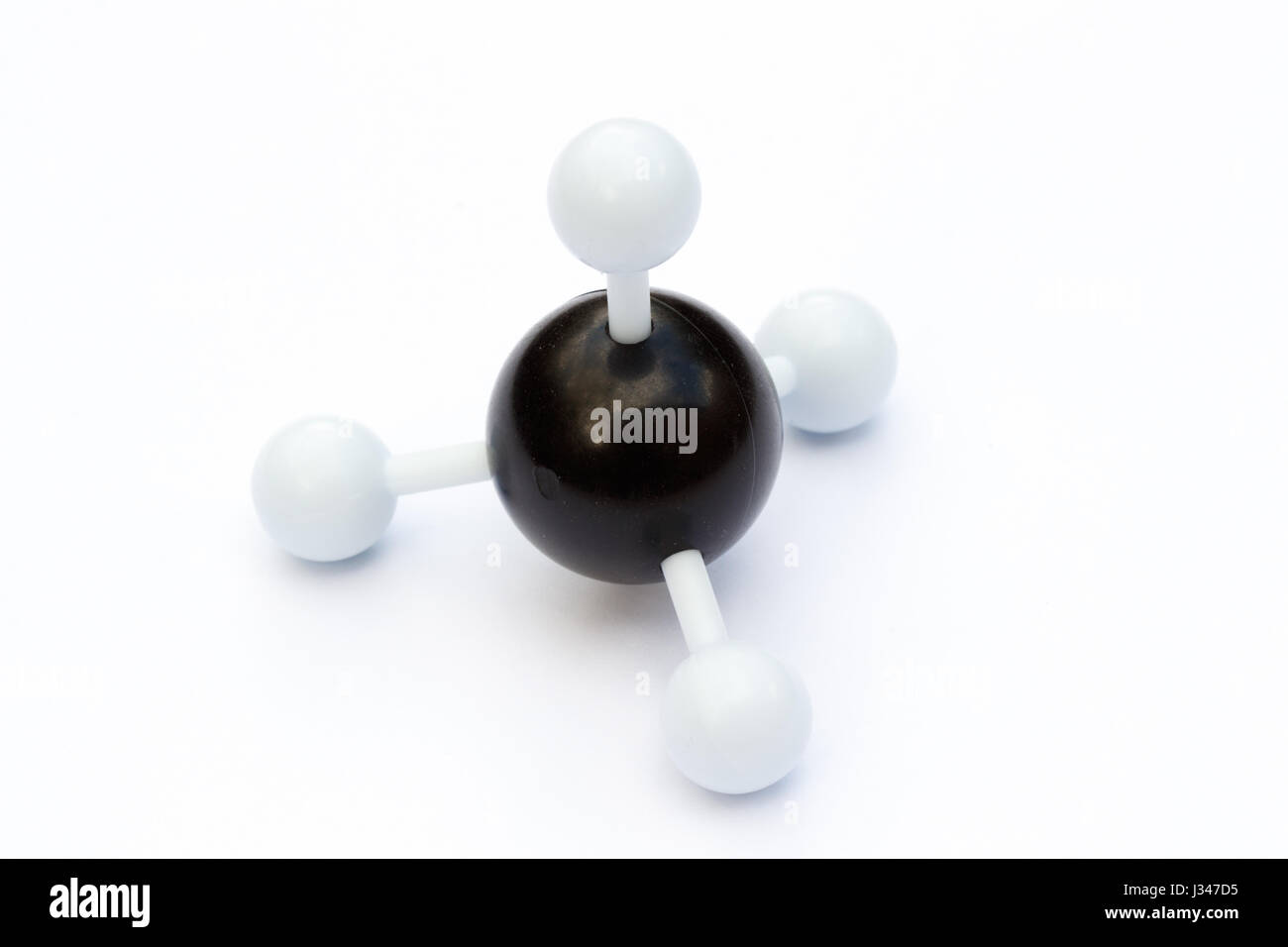 Plastic ball-and-stick model of methane (CH4) on a white background ...