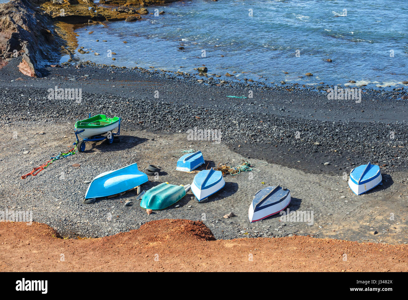 Green Lagoon at El Golfo with fishing boats on the beach, Lanzarote ...