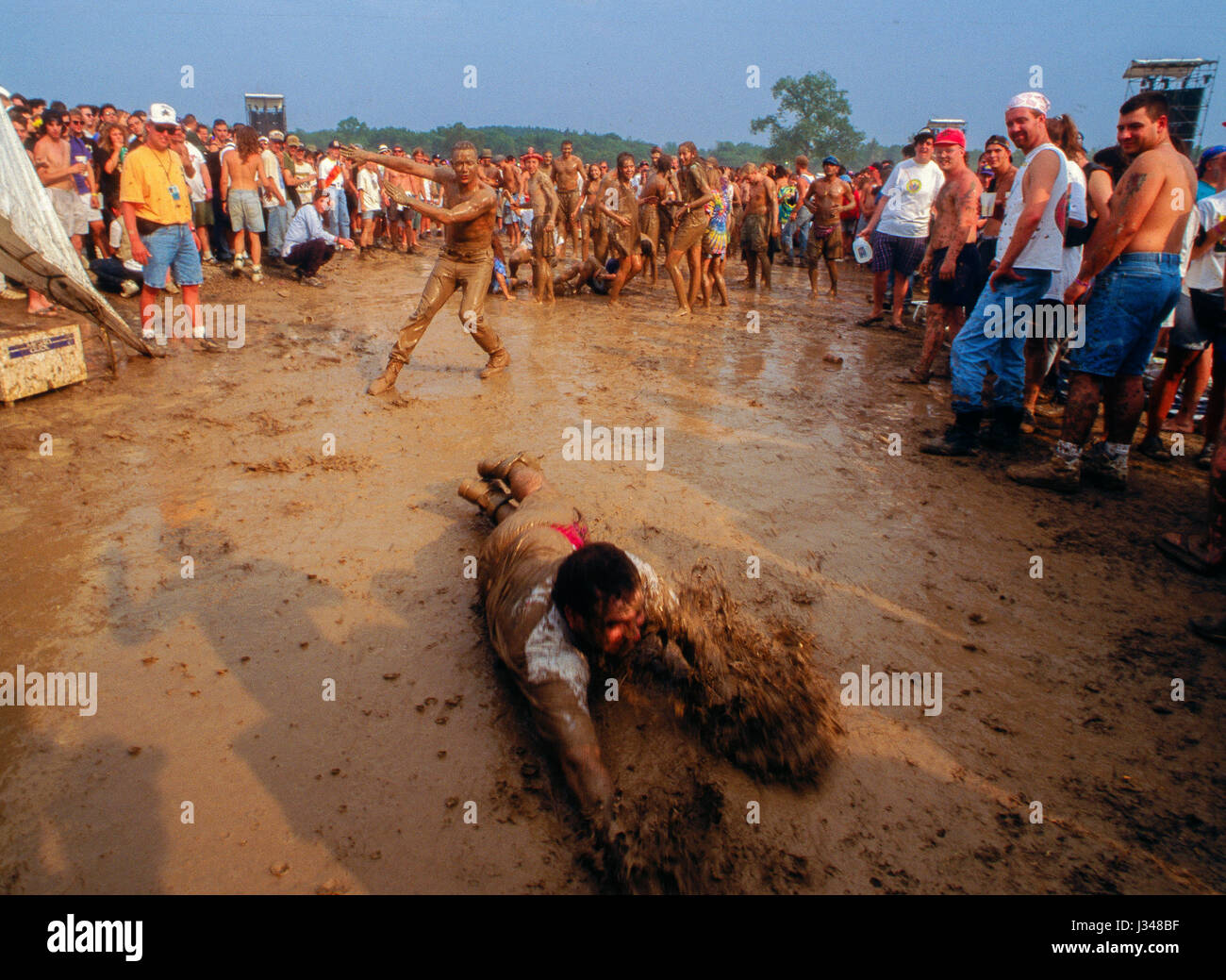 Concert goers at the 25th anniversary concert of Woodstock slide and ...
