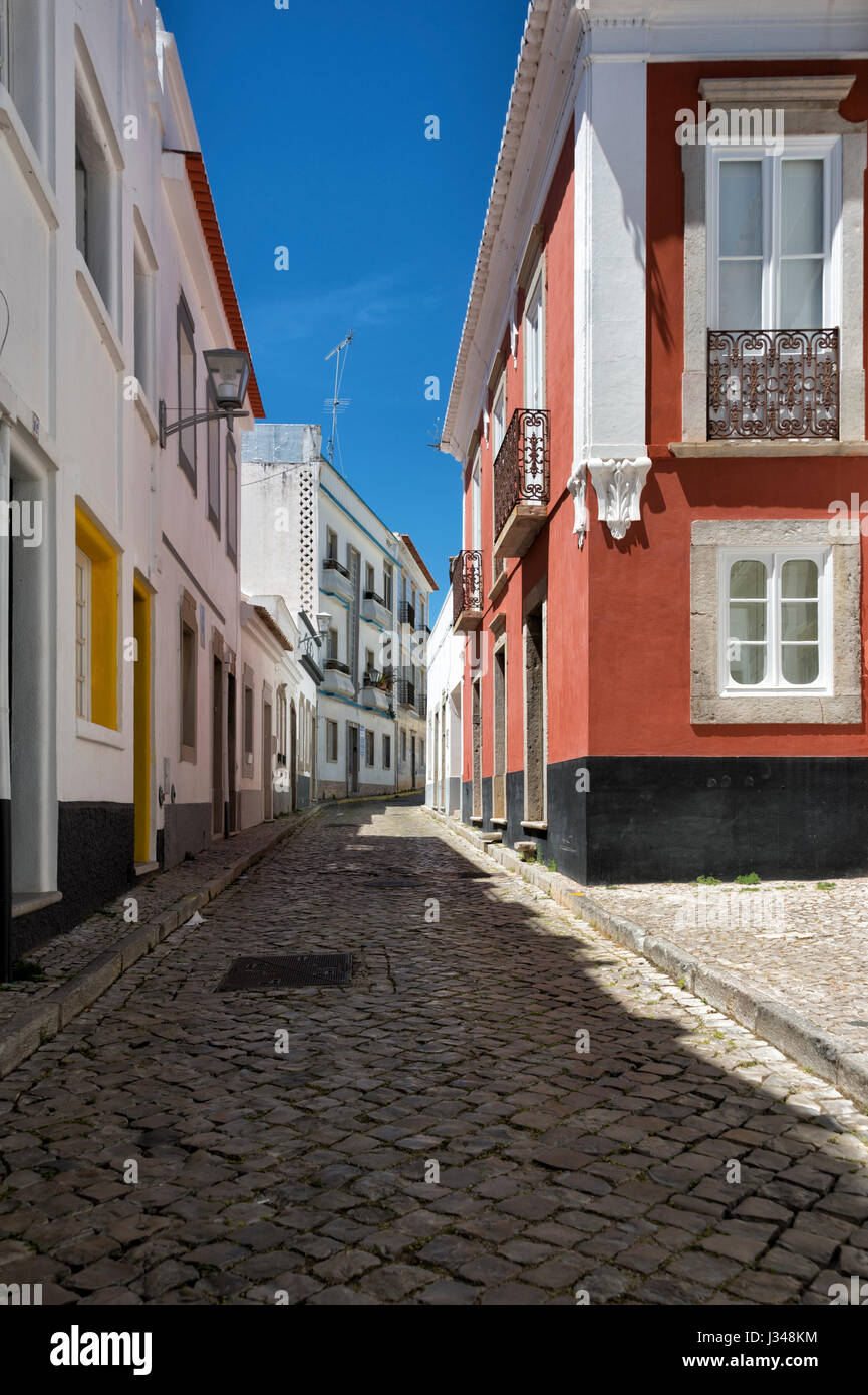 Traditional cobbled street and buildings in Tavira old town in the ...