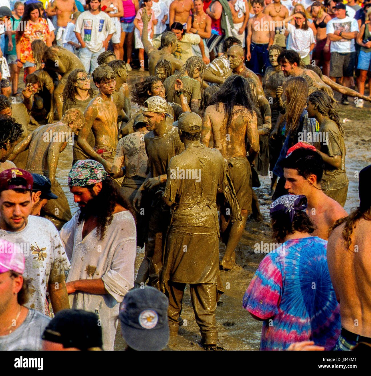 Concert goers at the 25th anniversary concert of Woodstock slide and ...