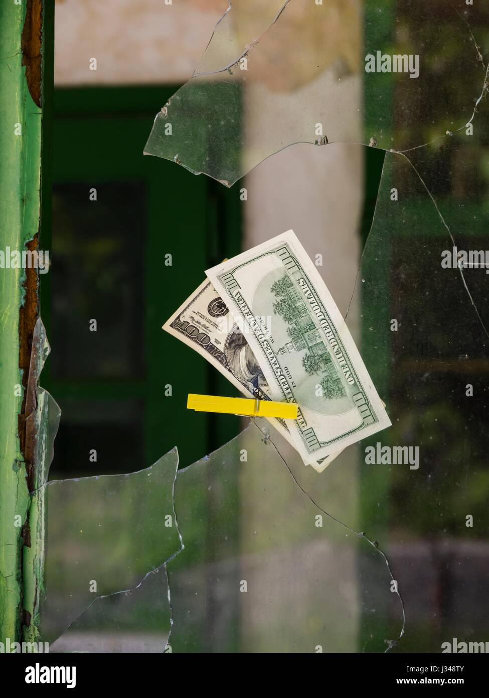 Money attachment broken window , value valued Stock Photo - Alamy