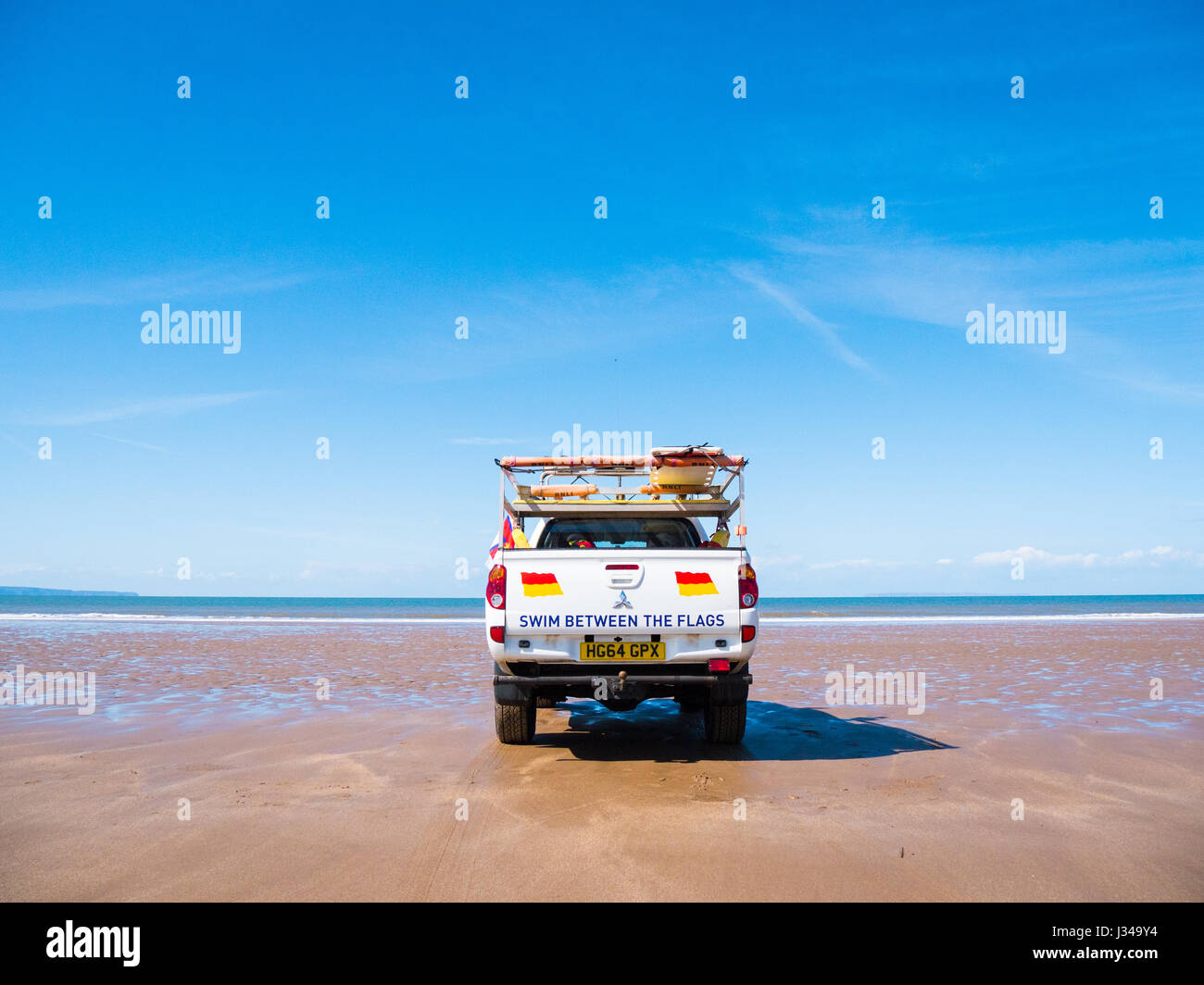 RNLI lifeguard pick up truck parked on Croyde beach near the surf on a ...
