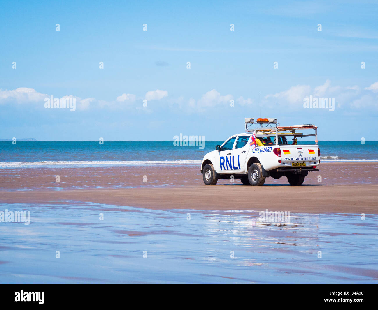 RNLI lifeguard pick up truck parked on Croyde beach near the surf on a ...