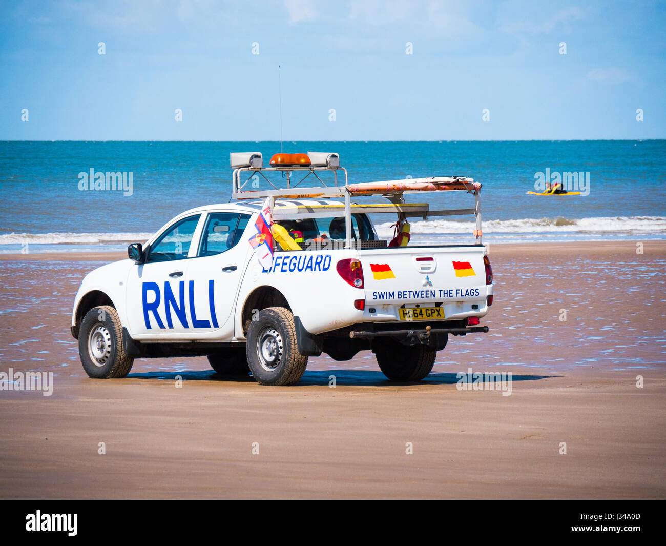 RNLI lifeguard pick up truck parked on Croyde beach near the surf on a ...