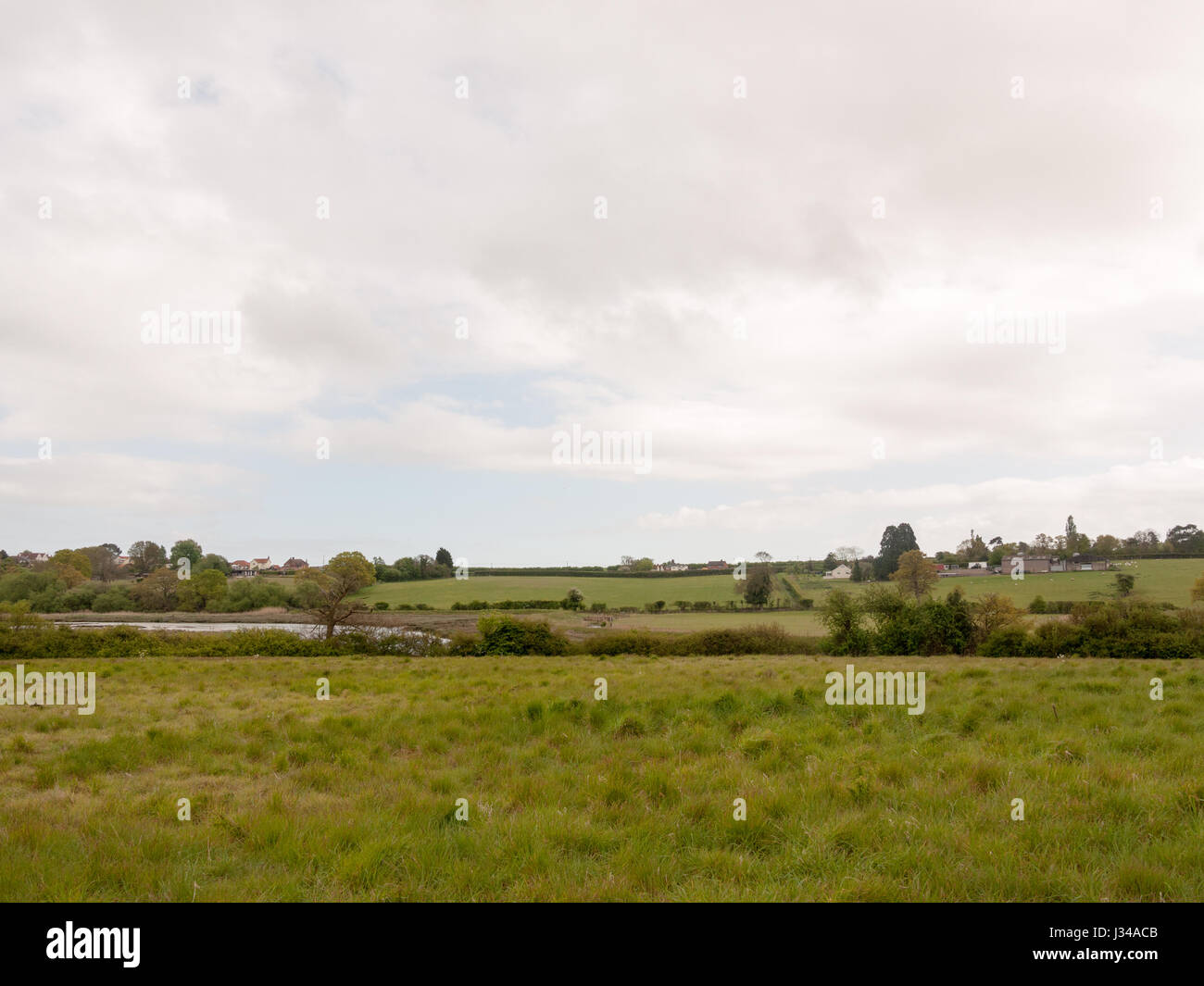 an overcast and cloudy countryside scene outside in an open field Stock ...